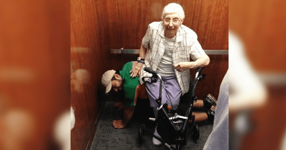 Young Man Acts As Human Chair To Support Elderly Lady Stuck In Elevator